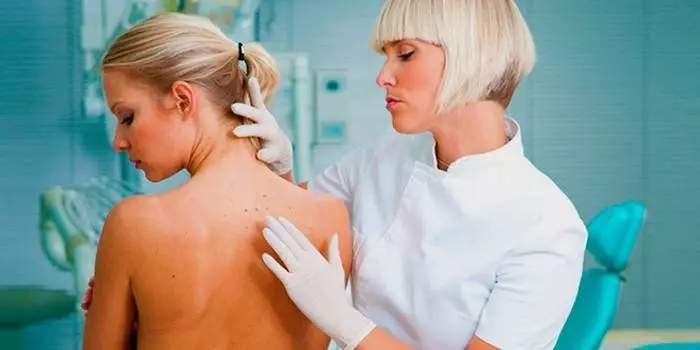 Dermatologist jeżamina l-ġilda ta 'mara