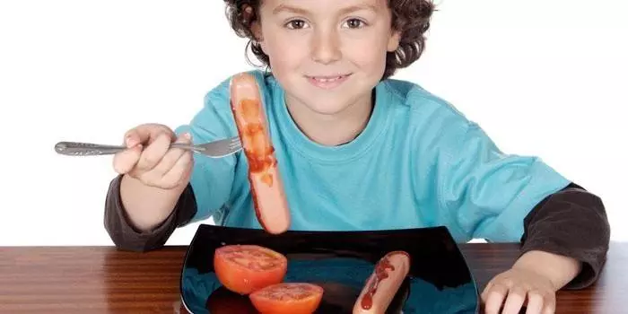 Boy eating sausages