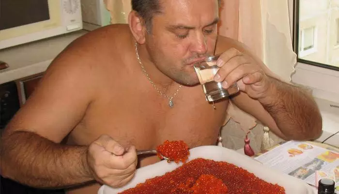 A man eats a delicacy at the table