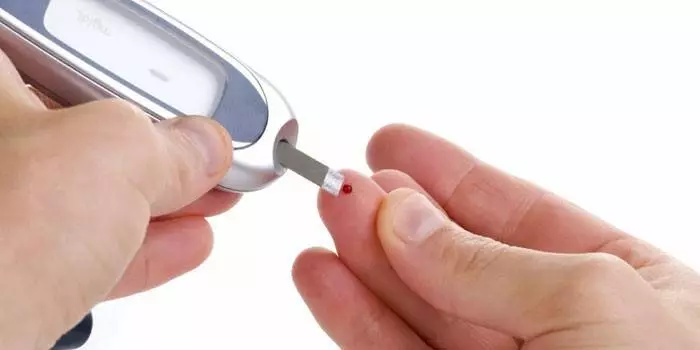 मानवी हातात रक्तातील ग्लुकोज मीटर