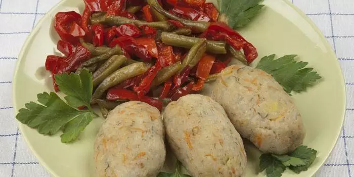 Pollock cutlets and pickled vegetables on a plate