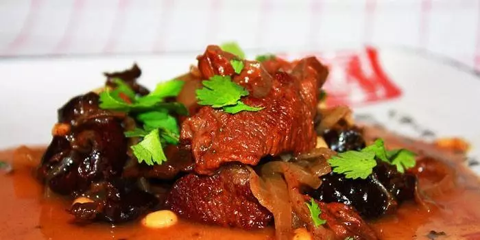 Beef stew with prunes and sauce on a plate