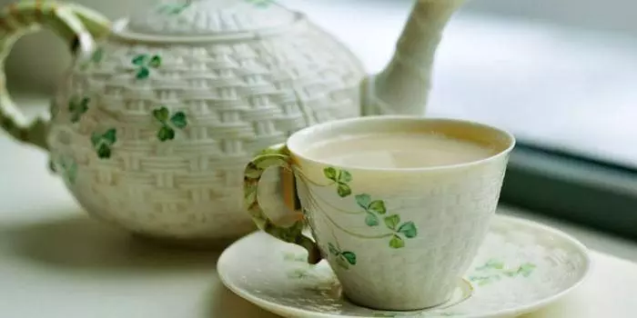 Green tea na may gatas sa isang tasa at teapot