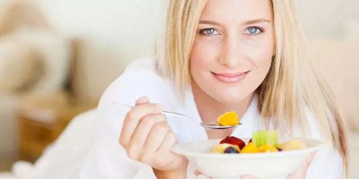 Girl eating fruit salad