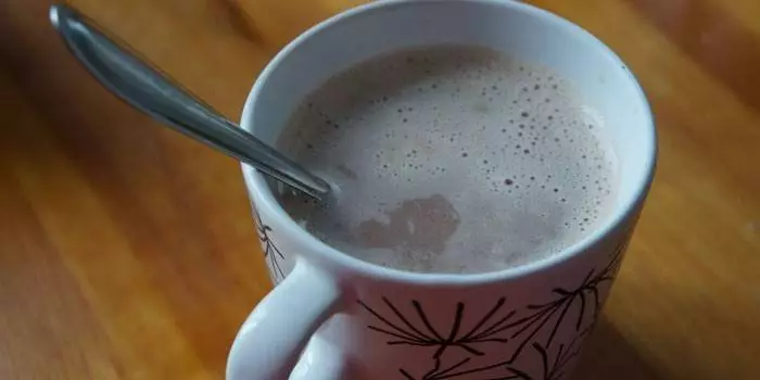 A cup of cocoa with milk