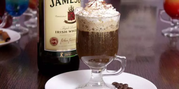 Irish coffee with whiskey and cream in a glass