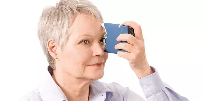 Elderly woman with non-contact eye pressure monitor