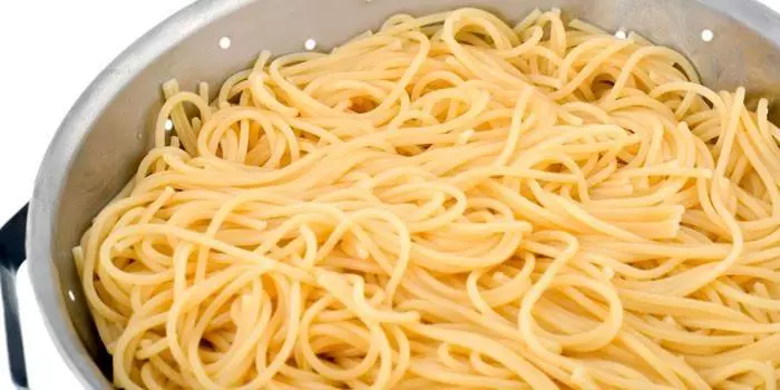 Boiled spaghetti in a colander