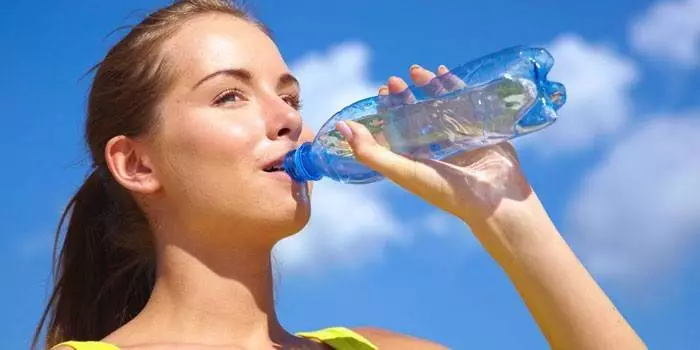 बोतल से पानी पीती लड़की