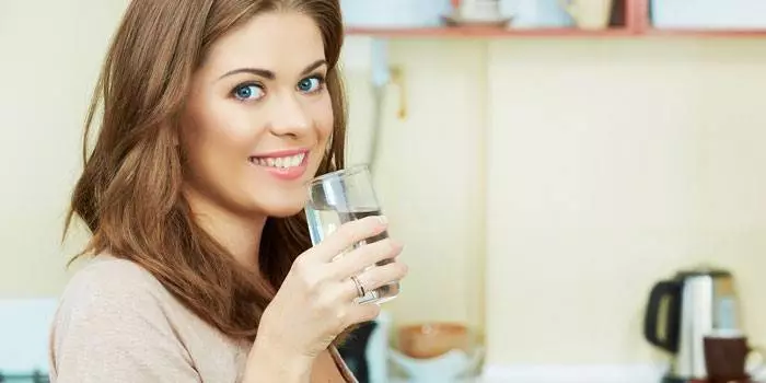 Fille tenant un verre d'eau