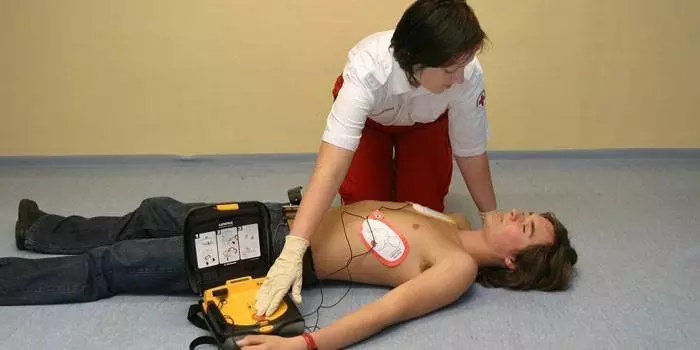 The girl provides first aid to the guy