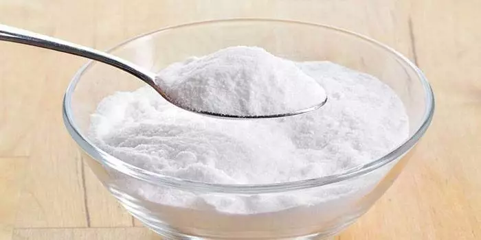 Bicarbonato di sodio in cucchiaio e piatto