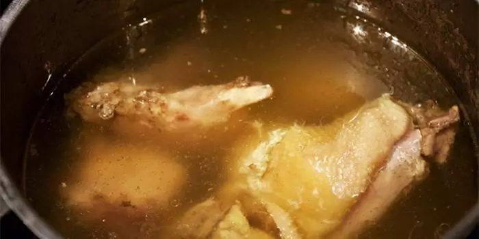 Chicken in broth in a saucepan