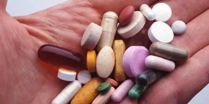 Tablets and capsules in the palm of your hand