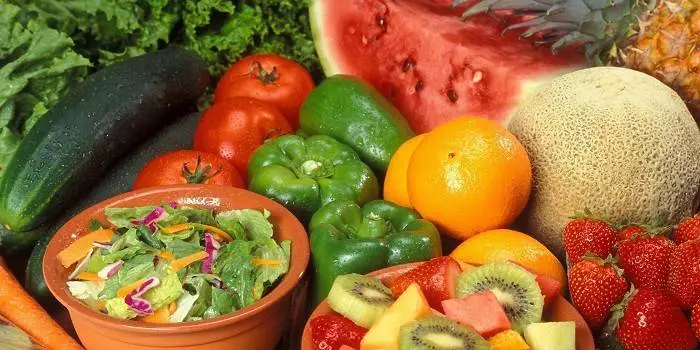 Vegetable and fruit salads in plates, fruits, berries and vegetables