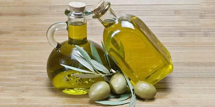 Olive oil bottles and olives