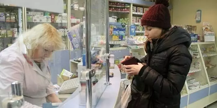 Girl and pharmacist in pharmacy