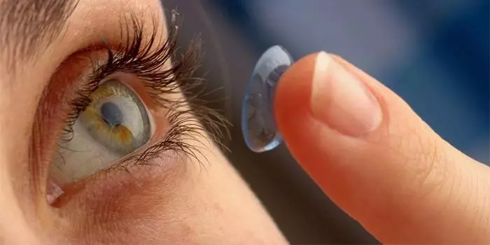 Girl with contact lens on her finger