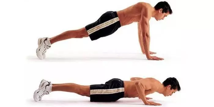A man performs push-ups from the floor in a classic technique