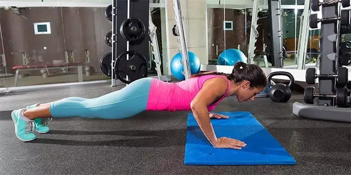 Girl push up from the floor in the gym