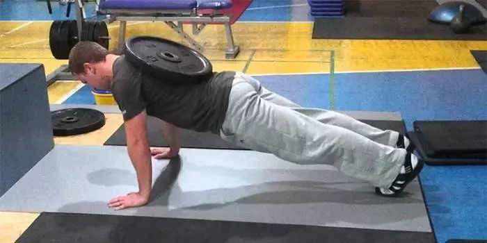 Man doing weighted push-ups