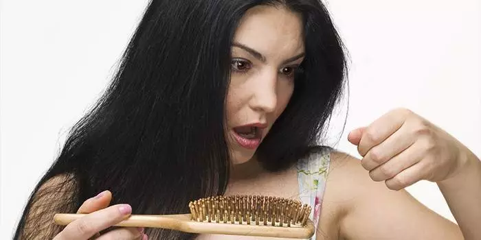 Woman looking at comb