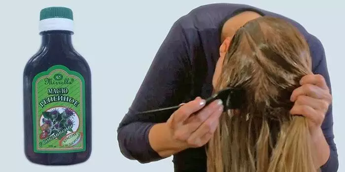 Woman applying burdock oil to her hair