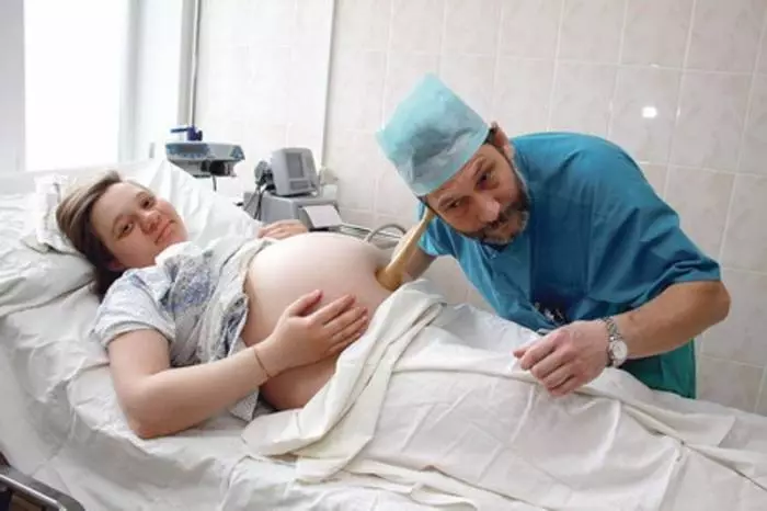 Ginecólogo masculino y mujer embarazada